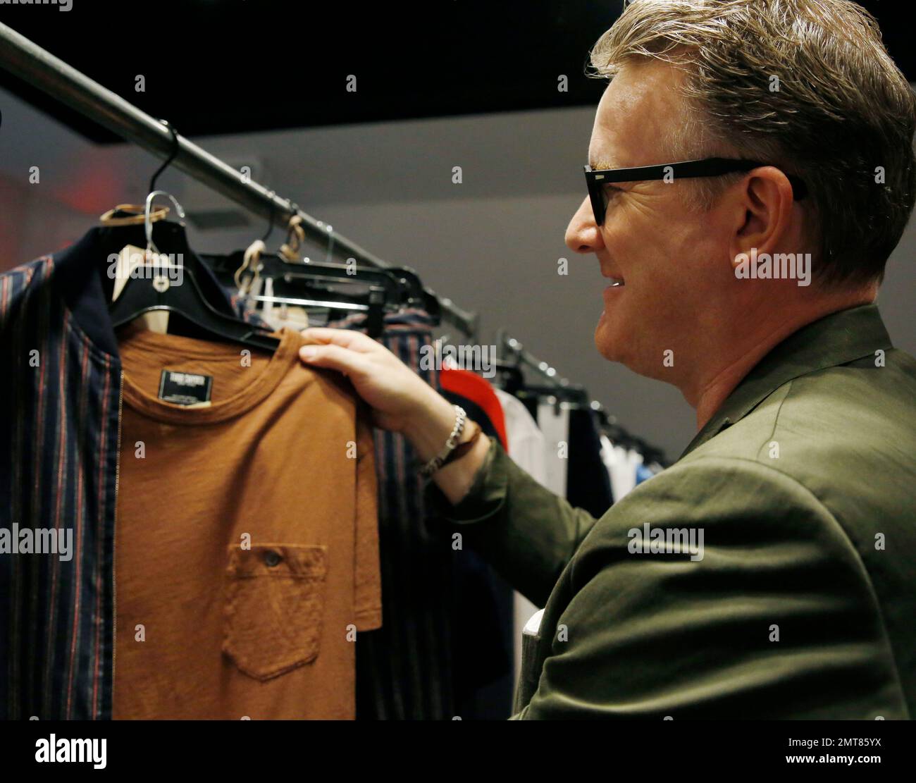 Designer Todd Snyder holds some of the clothes his models will wear ...