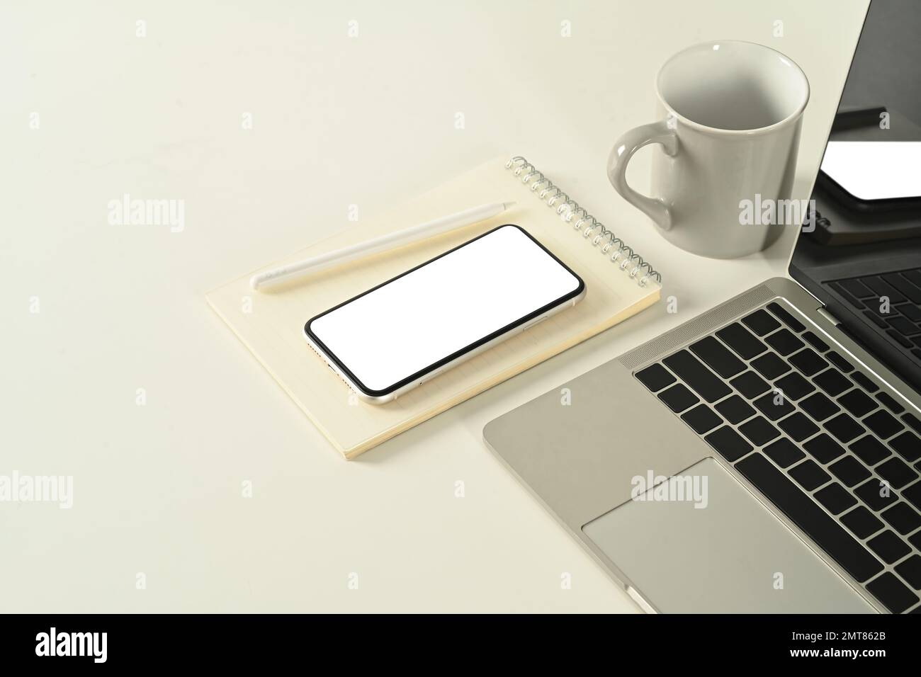 Mock up smart phone with white empty screen, notepad, coffee cup and ...