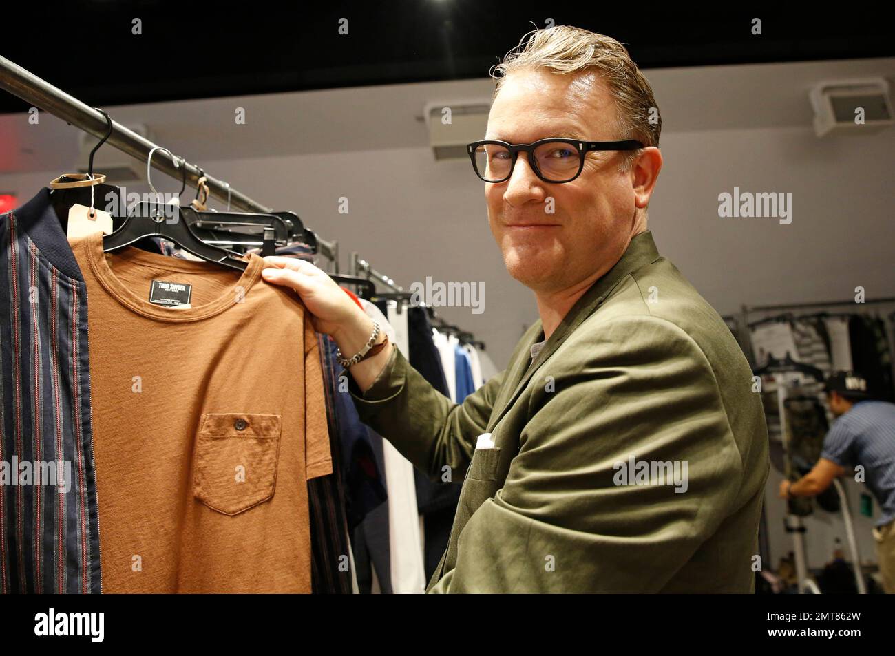 Designer Todd Snyder holds some of the clothes his models will wear ...