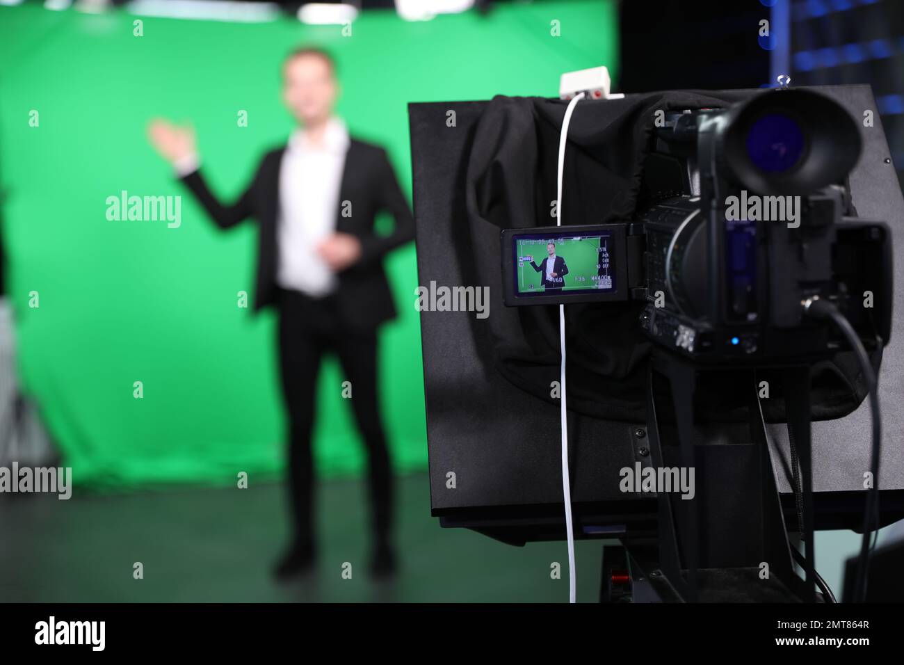 Presenter working in studio, focus on video camera screen Stock Photo ...
