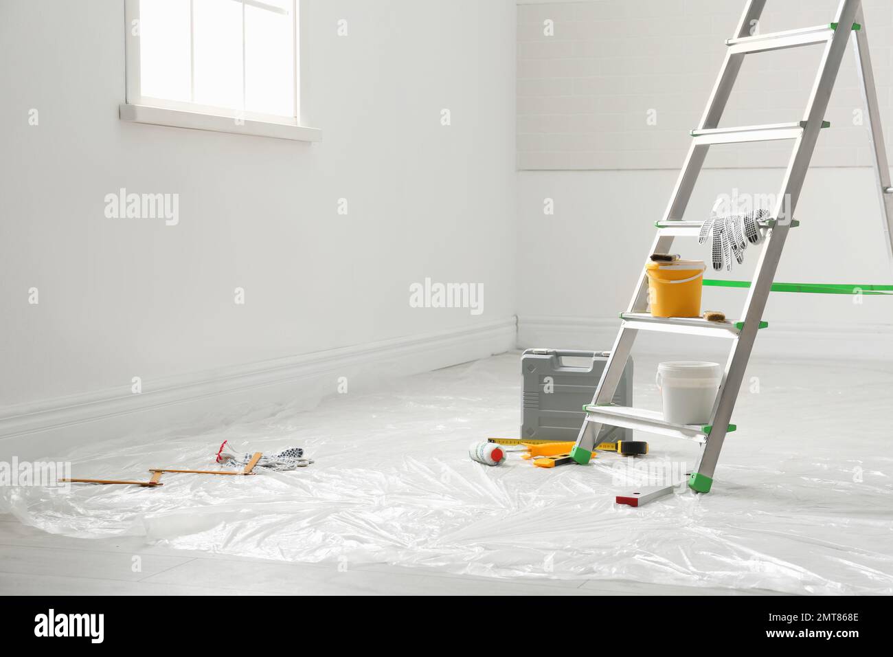 Stepladder and different tools in room. Interior renovation Stock Photo ...