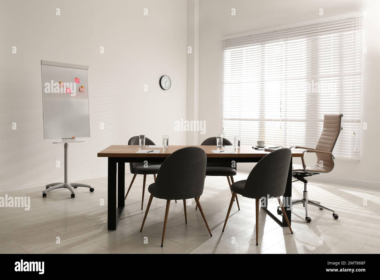 Simple office interior with large table and chairs Stock Photo - Alamy