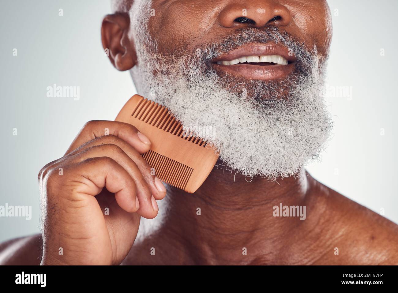 Grooming, comb and barber with beard of black man for beauty, hygiene ...