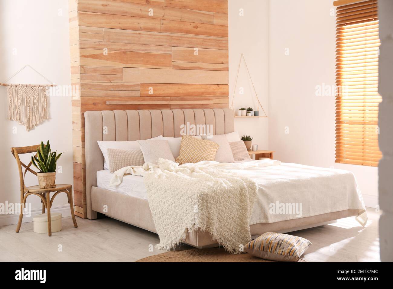 Stylish room interior with big comfortable bed Stock Photo - Alamy