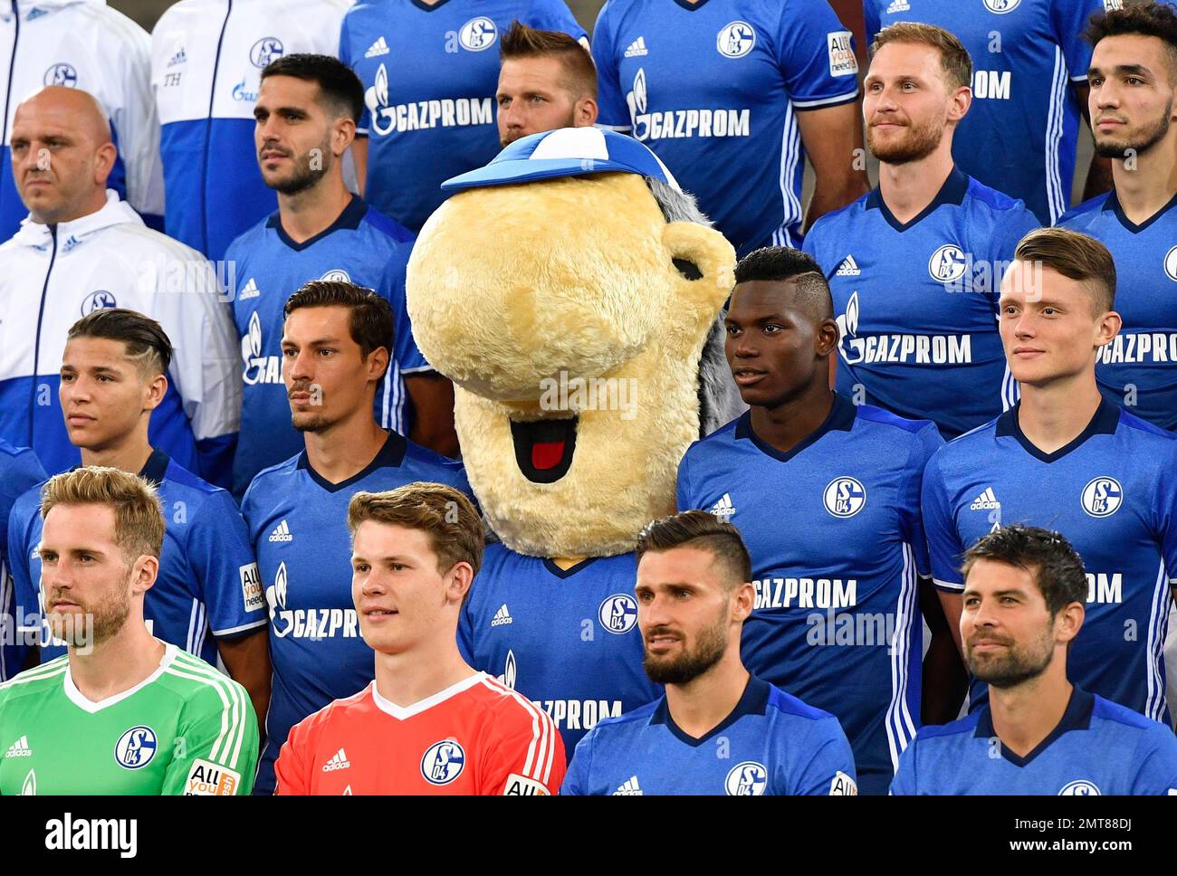 Schalke mascot Erwin poses between players during a team presentation ...