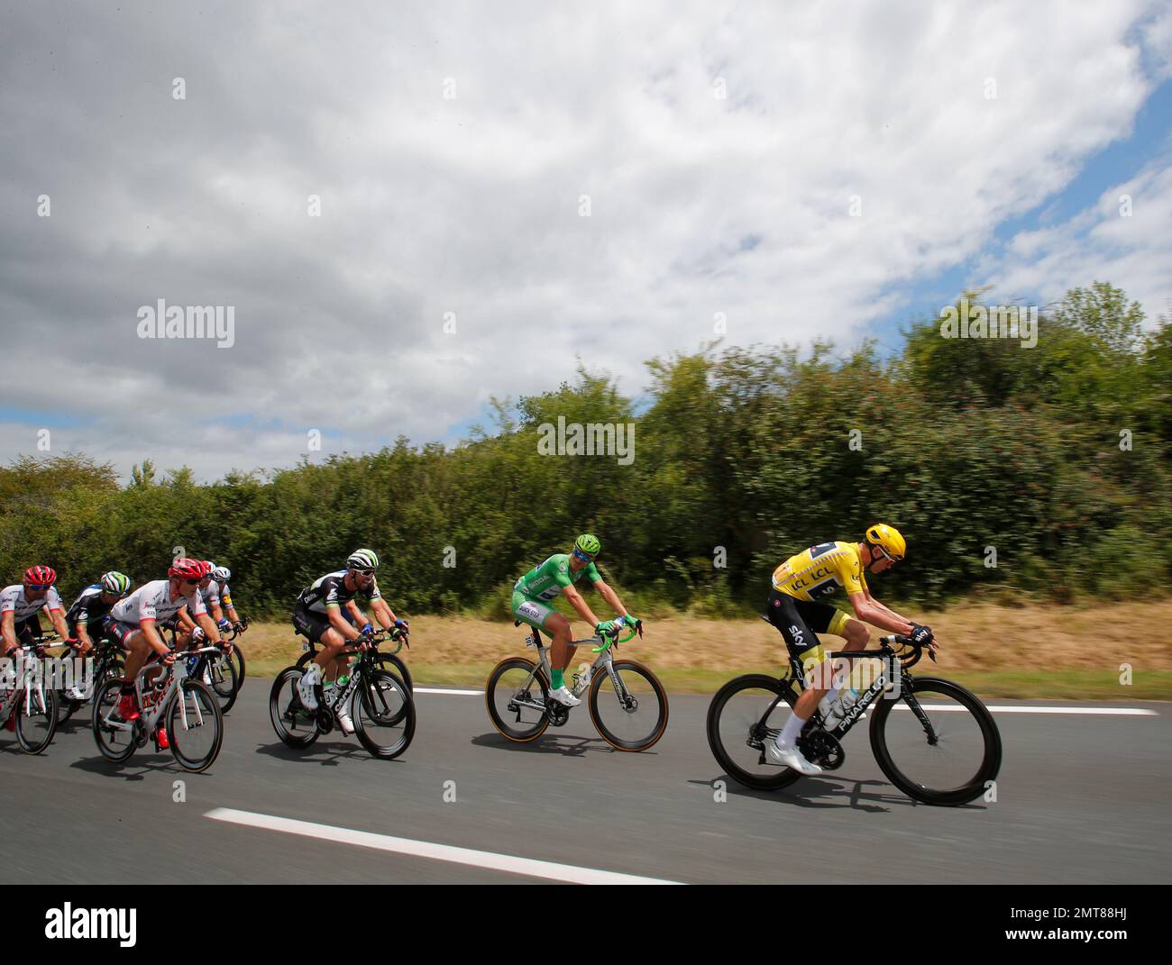 Britain's Chris Froome, wearing the overall leader's yellow jersey, and ...