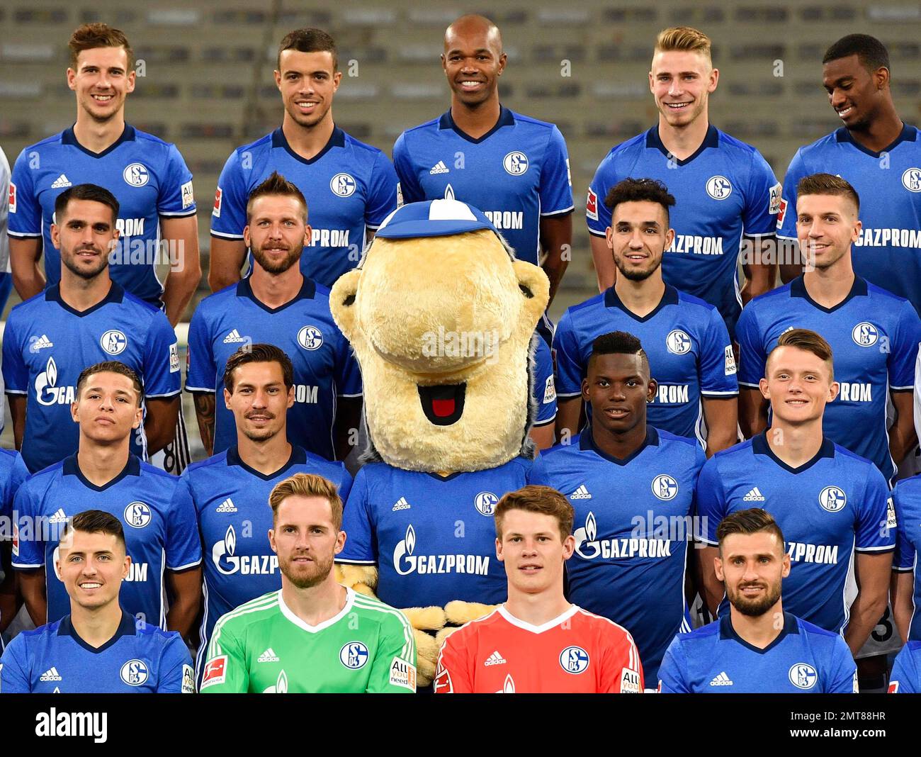 Schalke mascot Erwin poses between players during a team presentation ...
