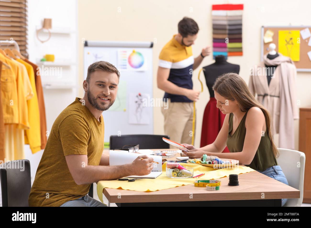 Fashion designers creating new clothes in studio Stock Photo - Alamy