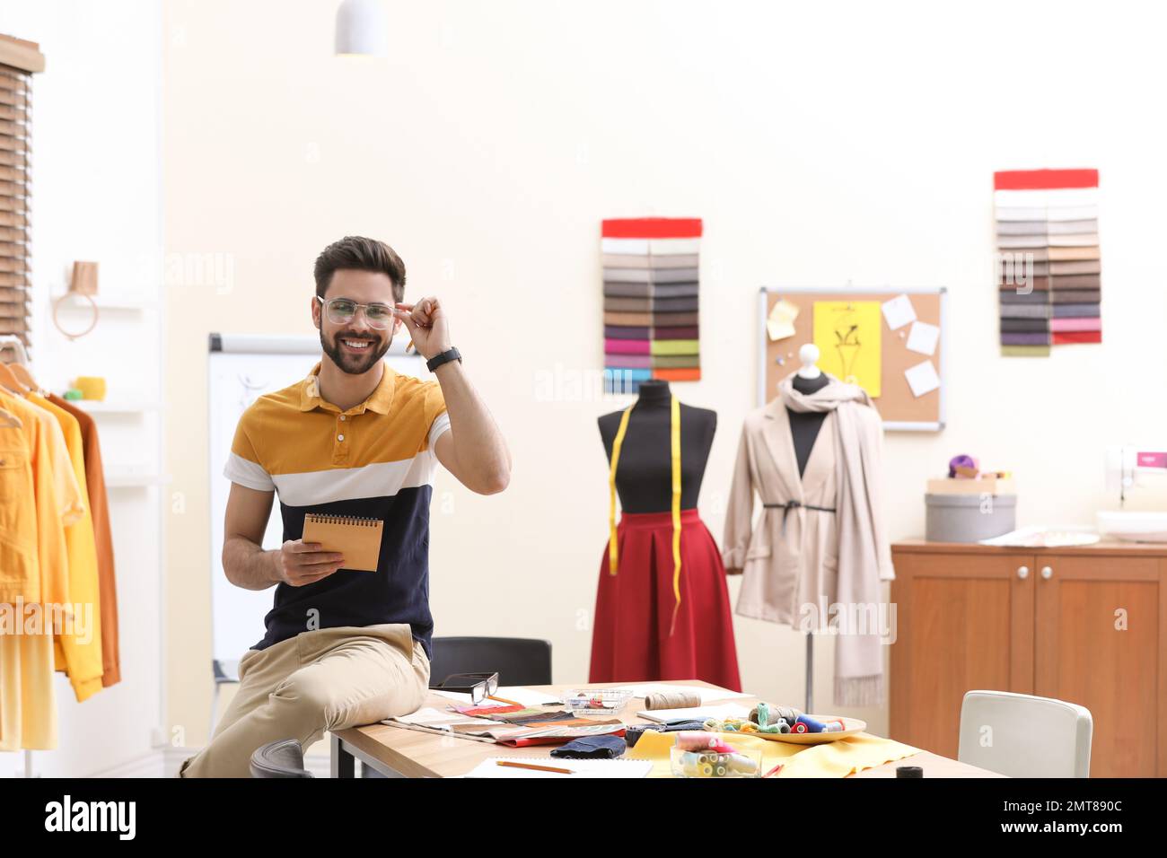 Fashion designer creating new clothes in studio Stock Photo - Alamy