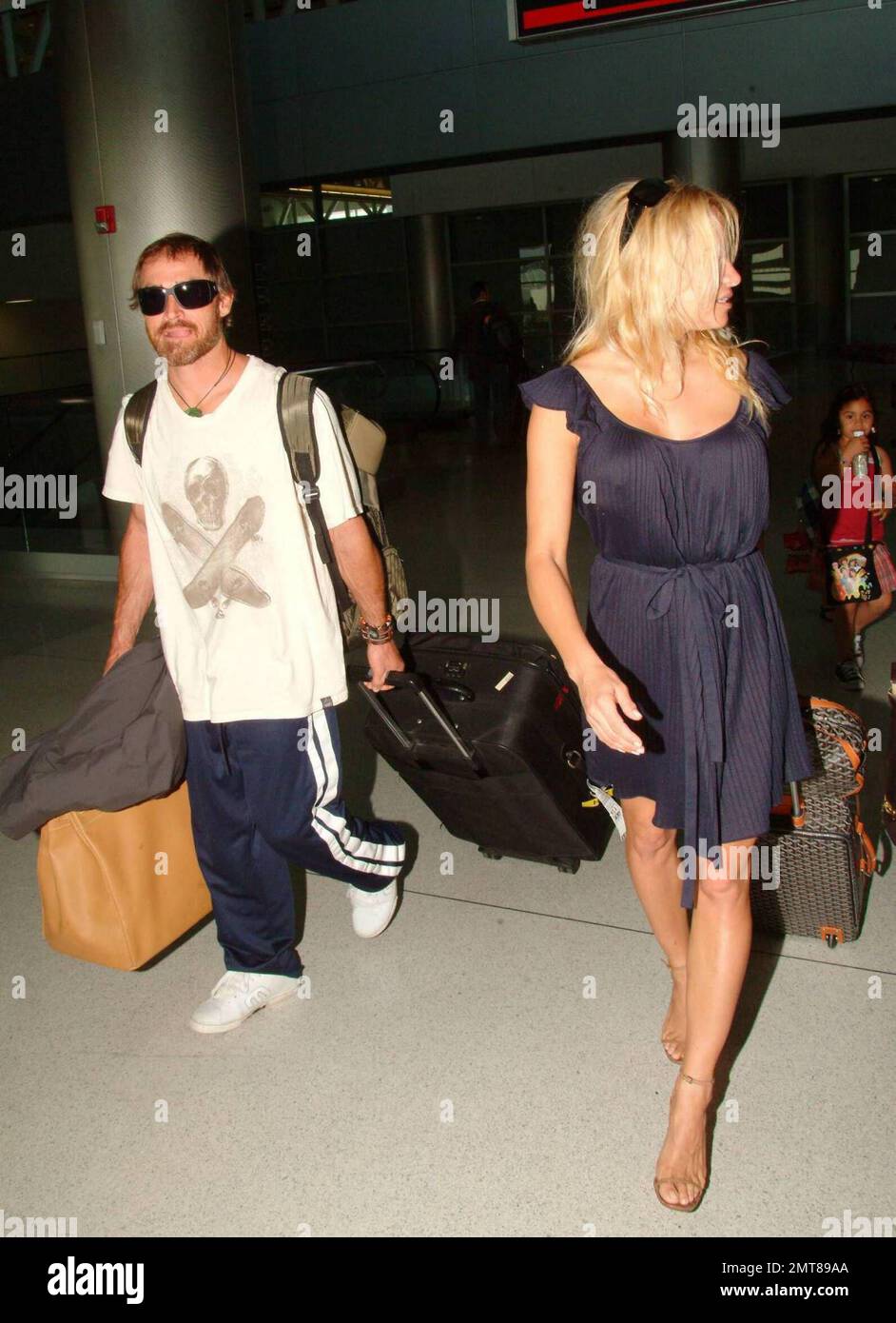 Exclusive!! Pamela Anderson arrives at Miami Intl Airport off of a ...