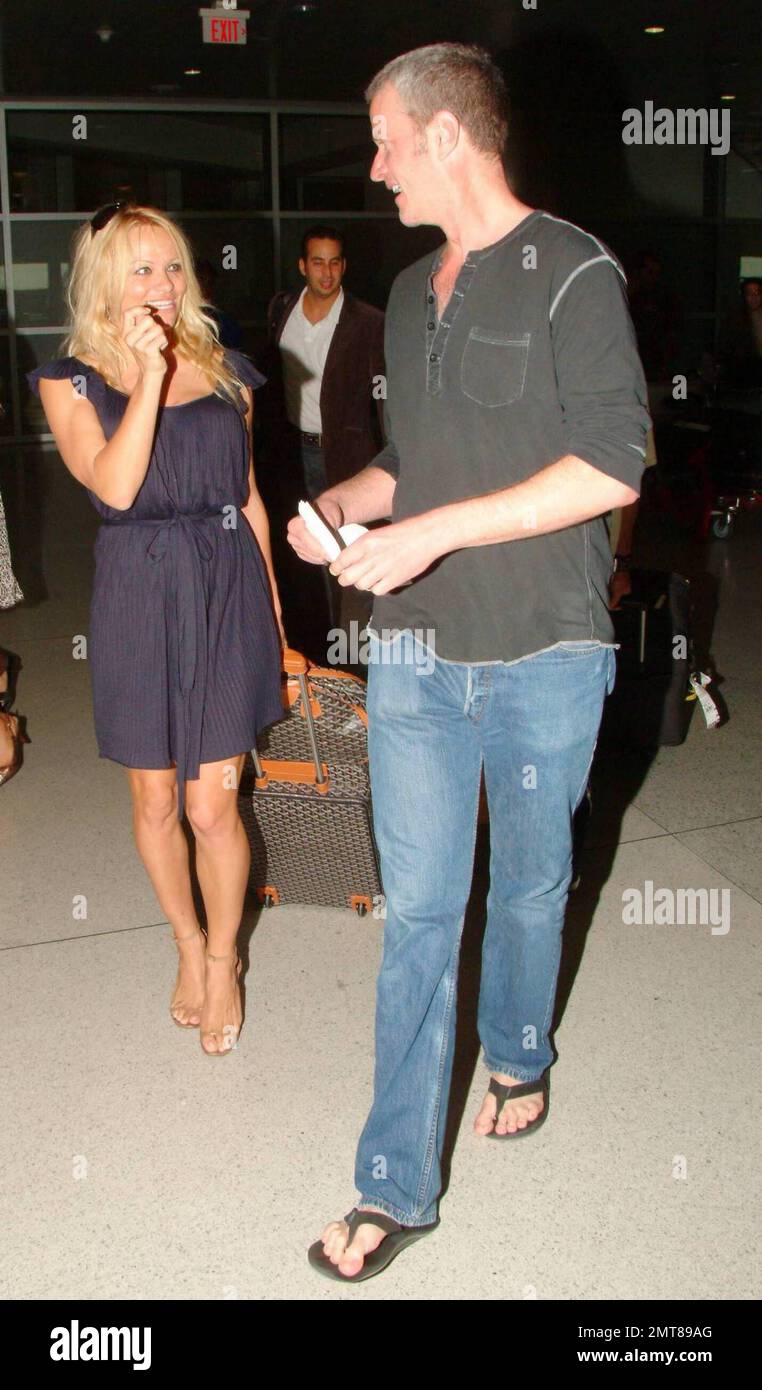 Exclusive!! Pamela Anderson arrives at Miami Intl Airport off of a ...