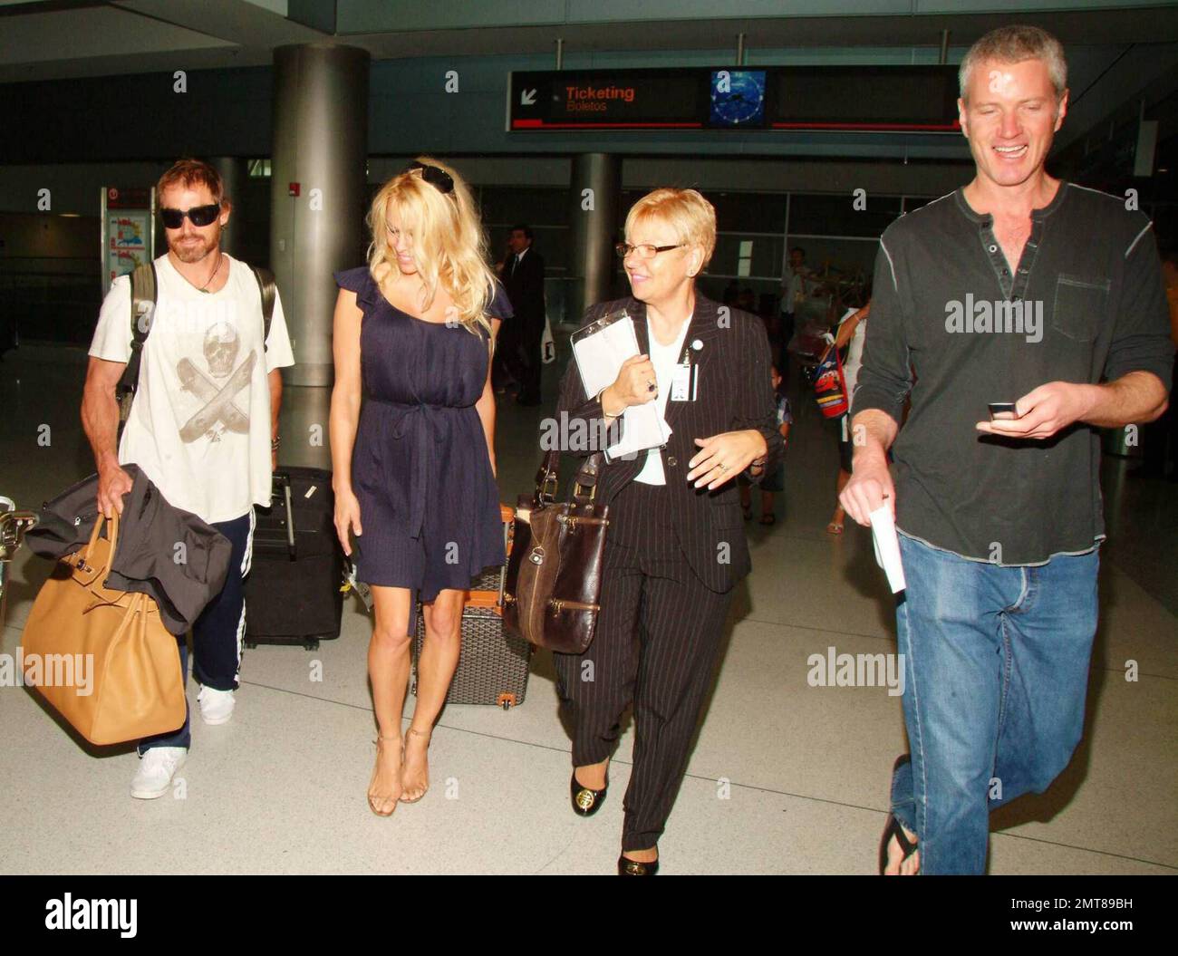 Exclusive!! Pamela Anderson arrives at Miami Intl Airport off of a ...