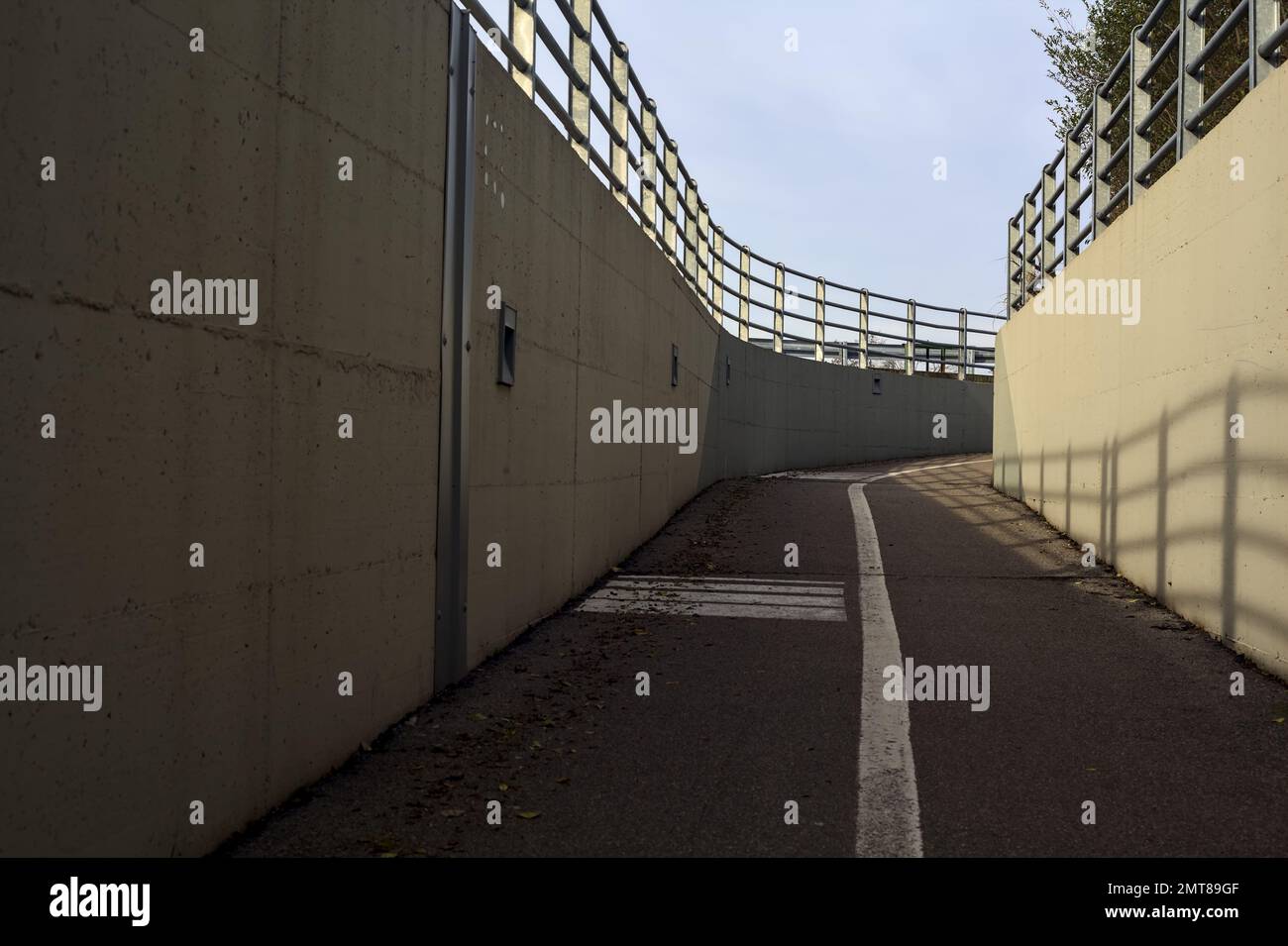 Bend in a passageway under a highway on a cloudy day Stock Photo - Alamy