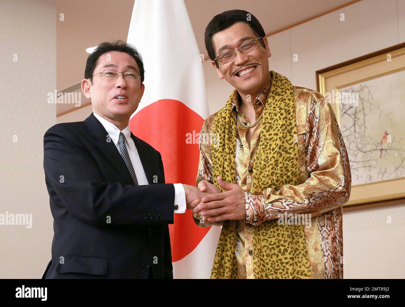 Japanese comedian Pikotaro, right, and Japanese Foreign Minister Fumio Kishida pose for a photo ...