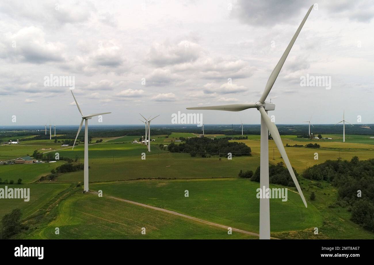 Wind turbines slowly spin in the wind at the High Sheldon Wind Farm ...