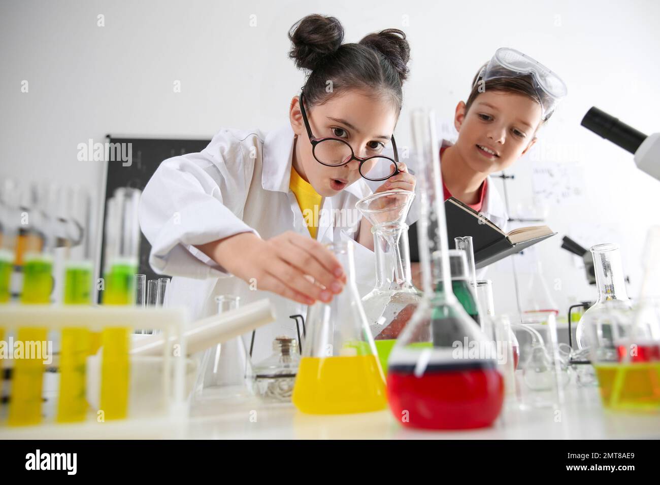 Smart pupils making experiment in chemistry class Stock Photo - Alamy