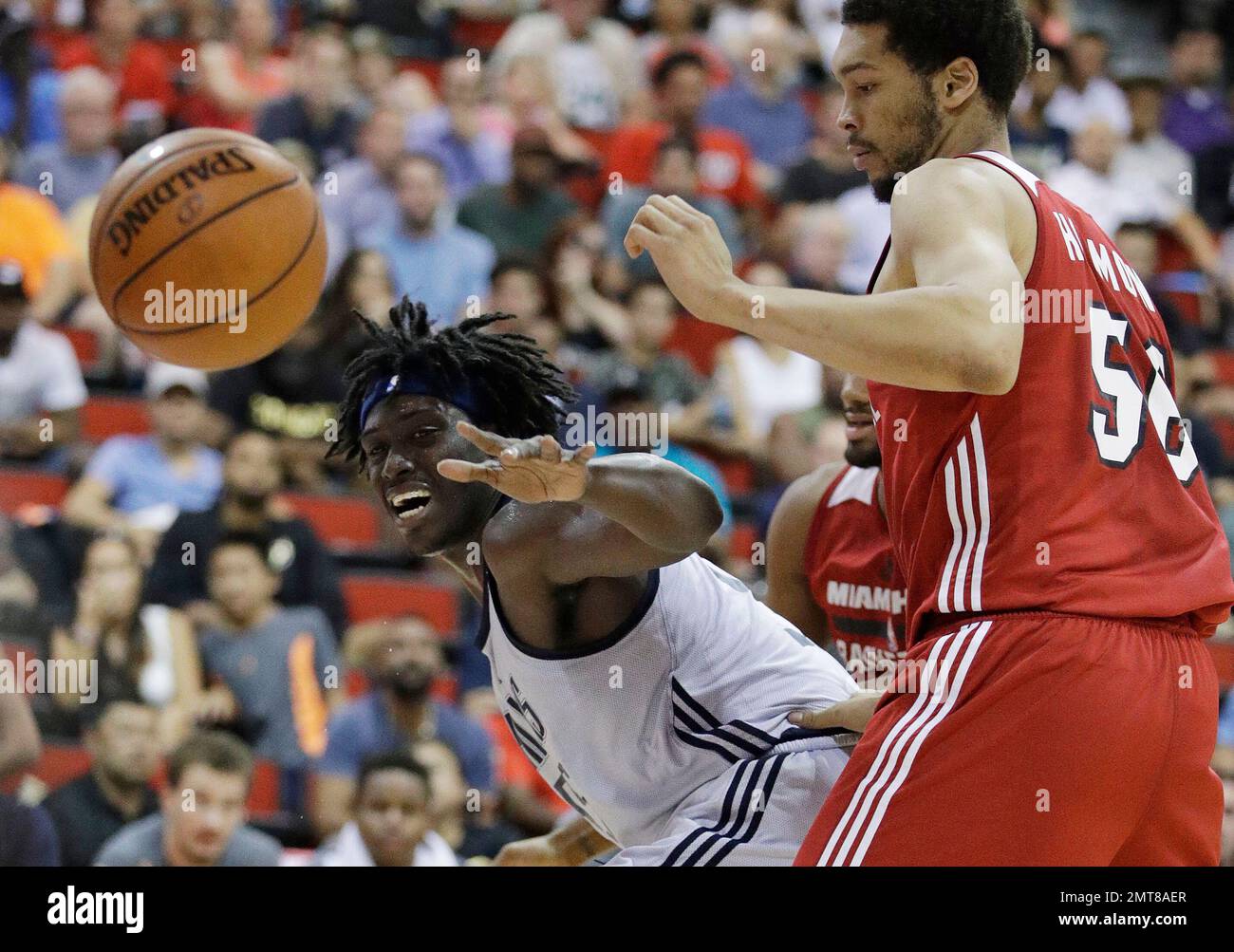 Dallas Mavericks' Johnathan Motley, left, battles for the ball with ...