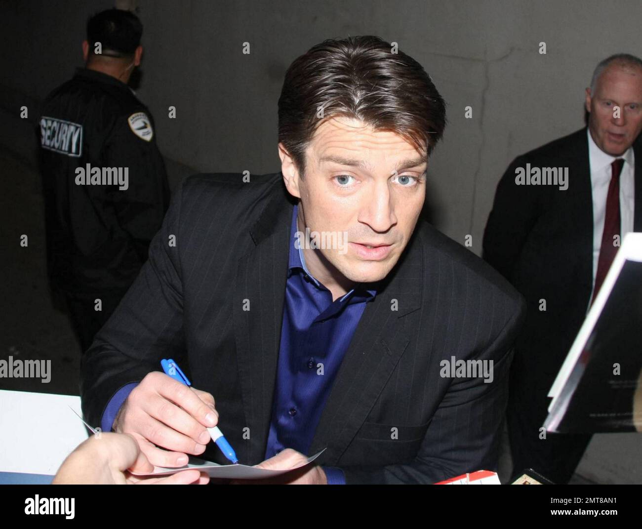 Nathan Fillion signs autographs for fans as he leaves the studios of ...