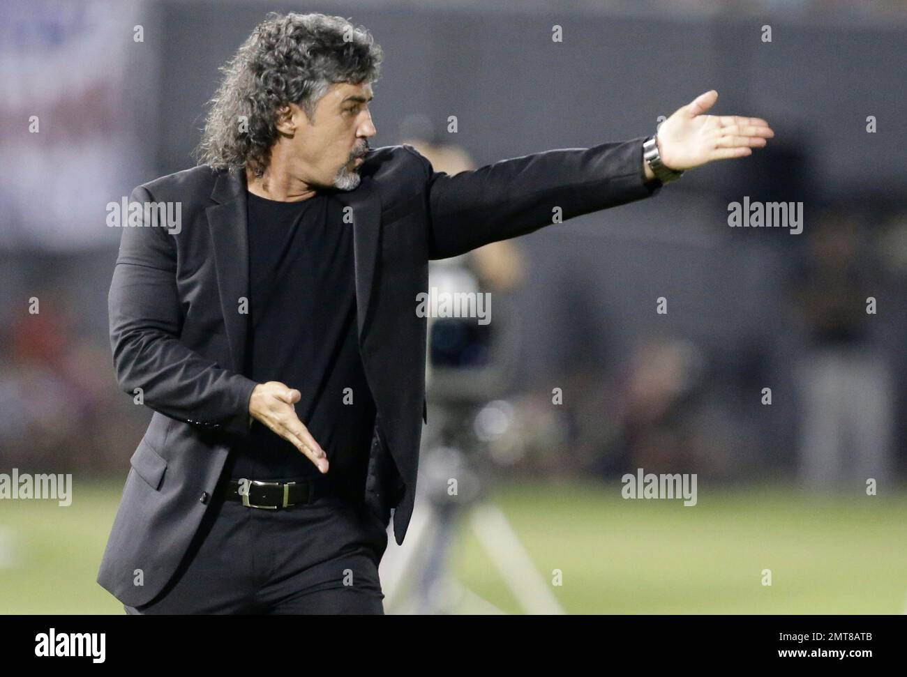 Coach Leonel Alvarez of Paraguay's Cerro Porteno gives instructions to ...