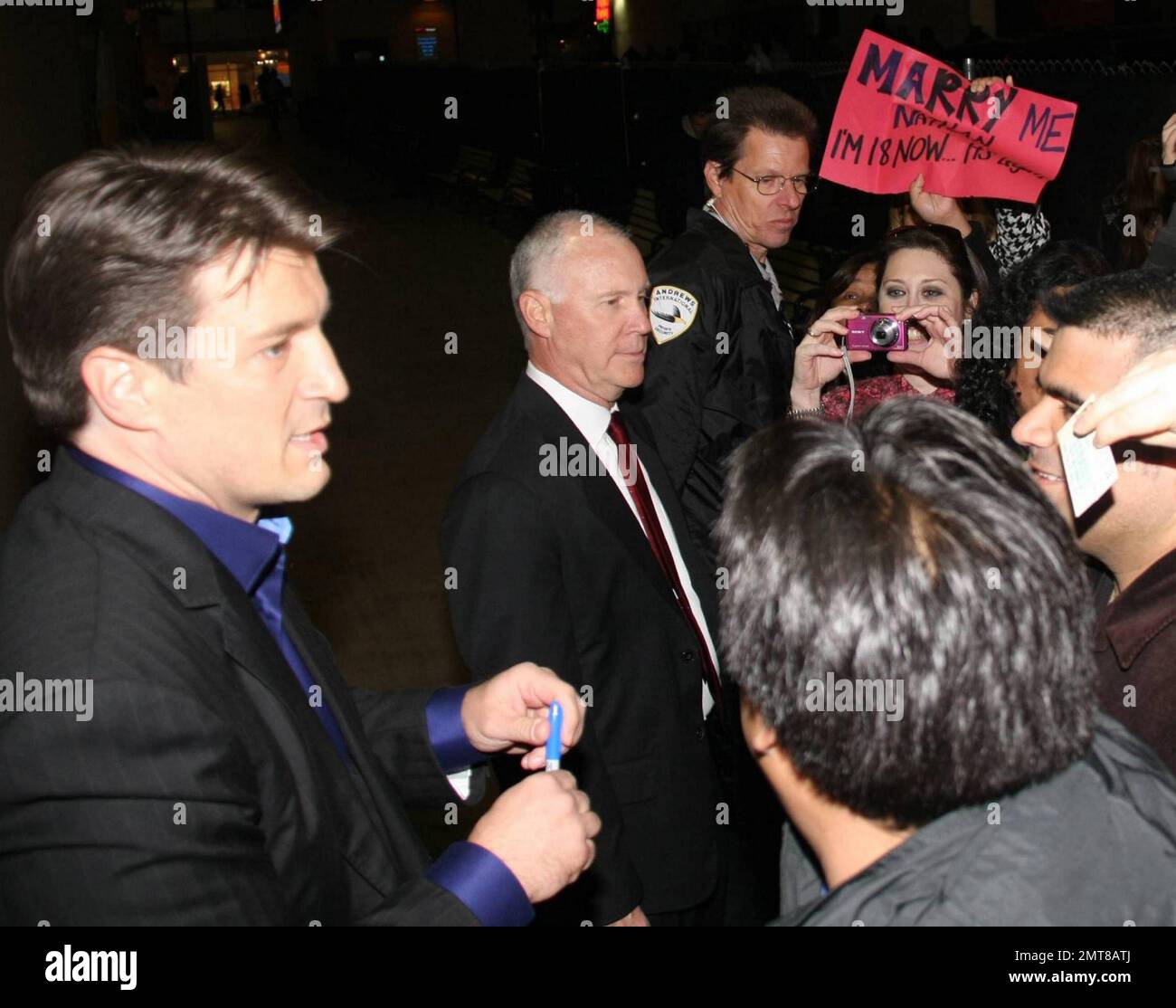 Nathan Fillion signs autographs for fans as he leaves the studios of ...