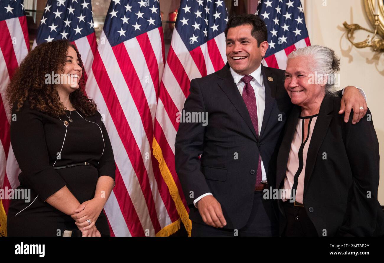 Representative-elect Jimmy Gomez, D-Calif., center, puts his arm around ...