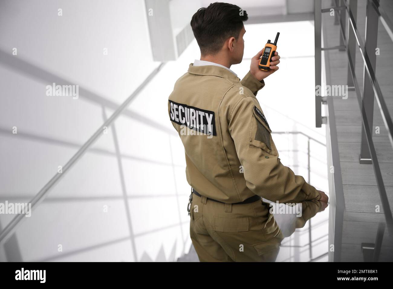 Professional security guard with portable radio set on stairs Stock ...