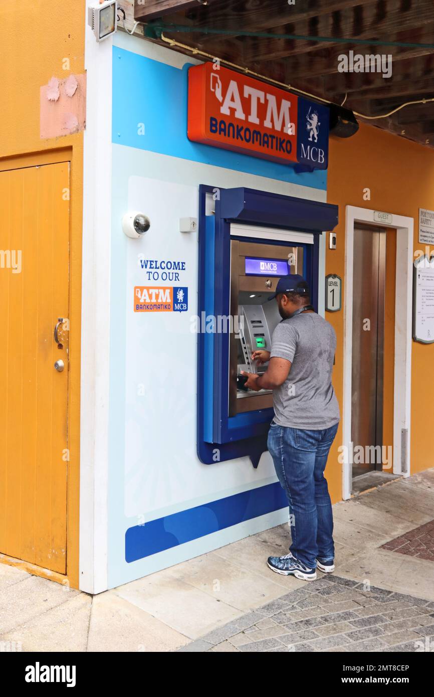 Man using cash machine, Willemstadt, Curacao Stock Photo - Alamy