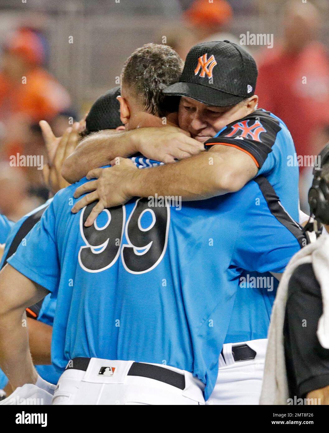 New York Yankees' Aaron Judge (99) is hugged by Danilo Valentine, right ...