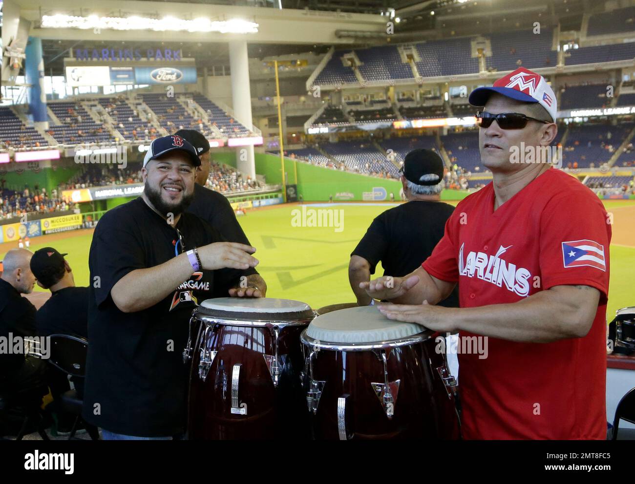 Alberto Reyes, left, and Luisito de Jesus, right, play the bongo drums ...
