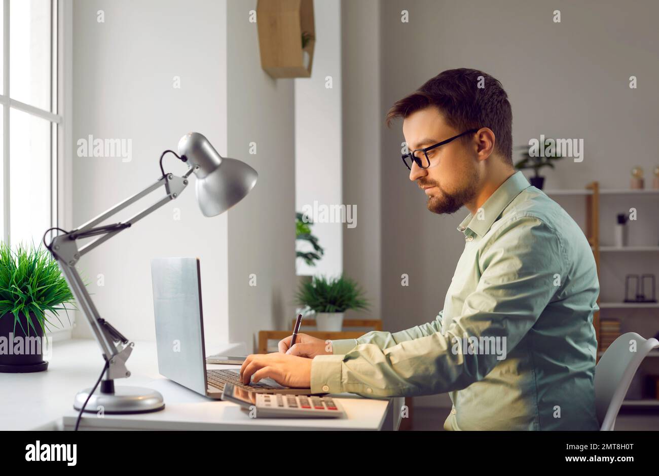 Financial manager working on spreadsheet on computer and calculating ...