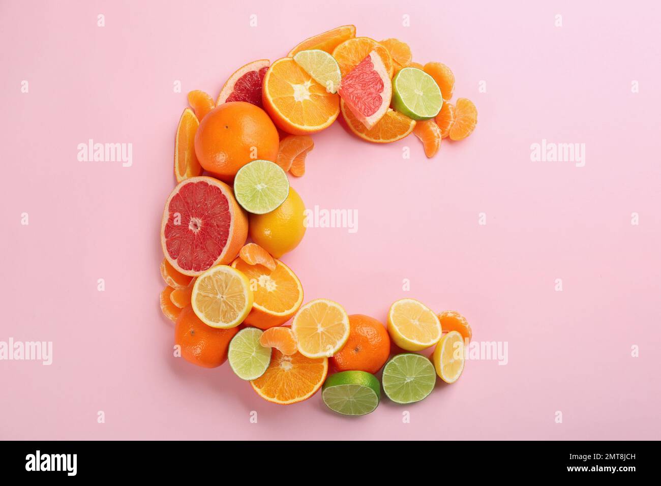 Letter C made with citrus fruits on pink background as vitamin ...