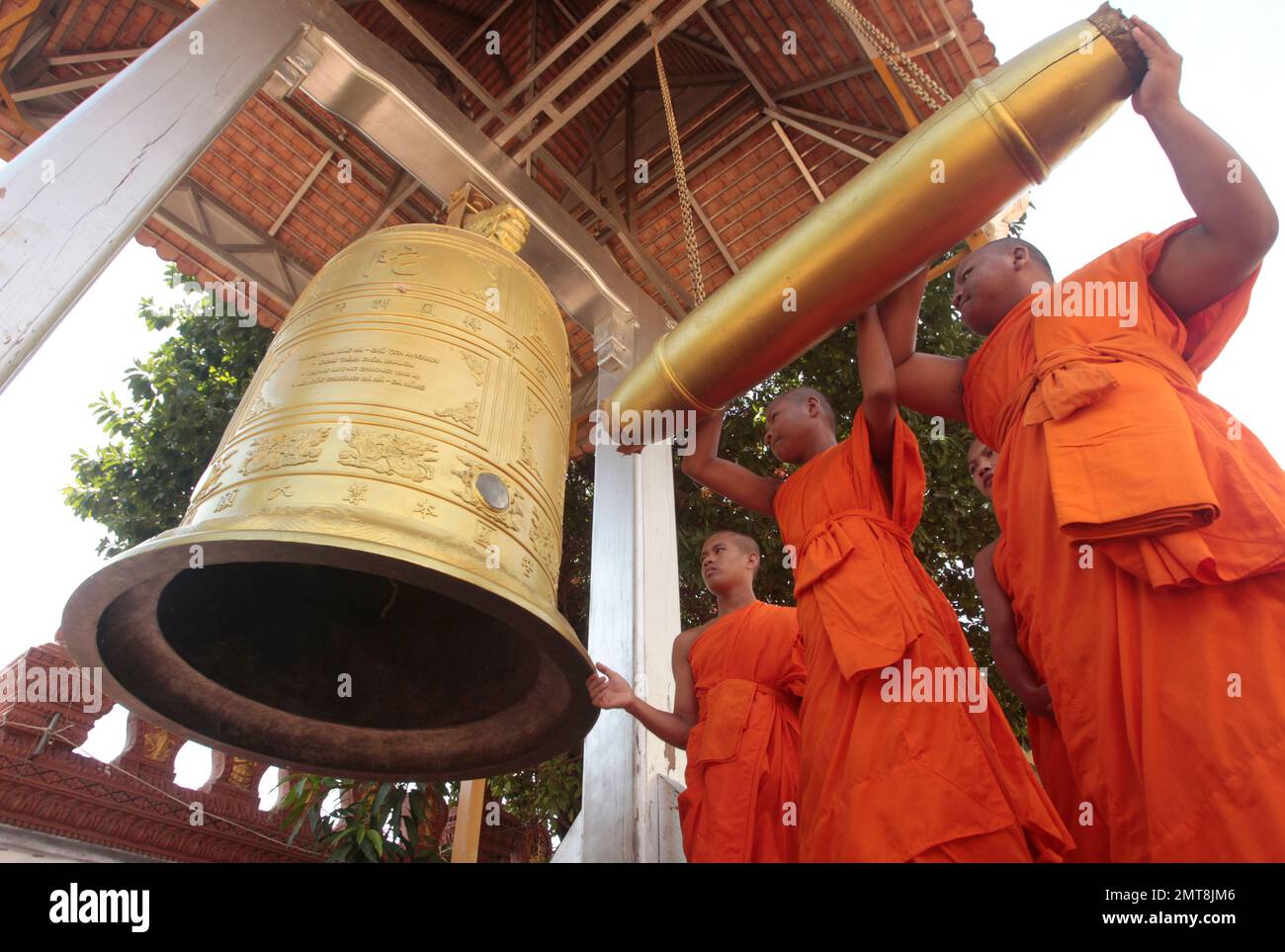 Cambodian Buddhist monks hit a gong at Unalom pagoda in Phnom Penh ...