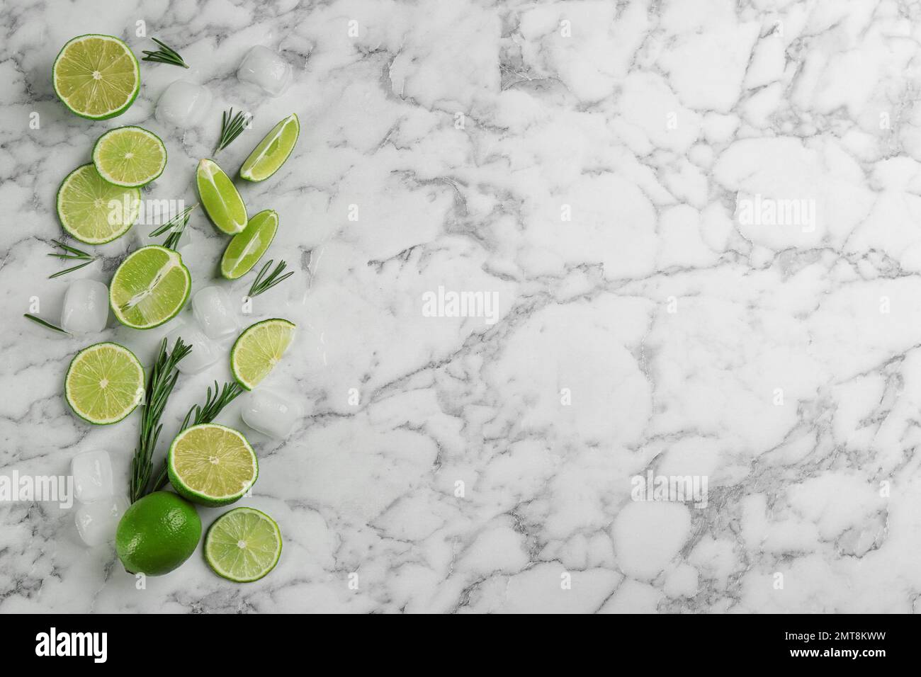 Lemonade layout with juicy lime slices, rosemary and ice cubes on white ...