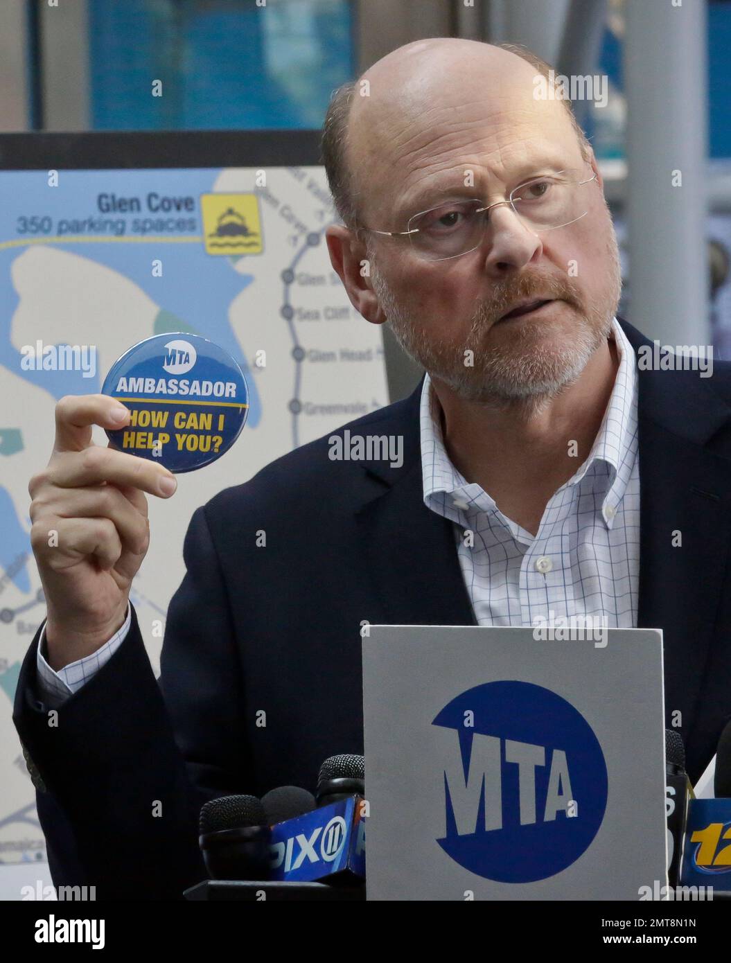MTA Chairman Joseph Lhota displays a badge during a news conference ...