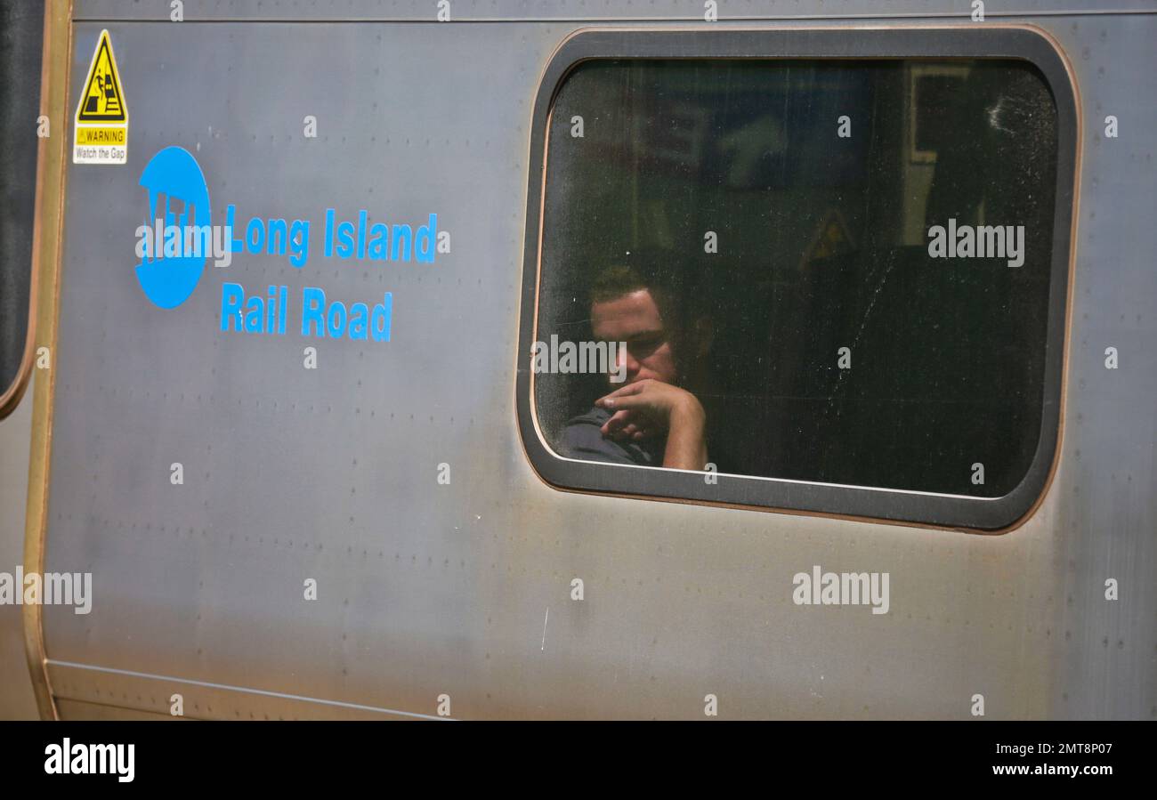 A passenger looks out the window of an Atlantic Terminal bound LIRR ...