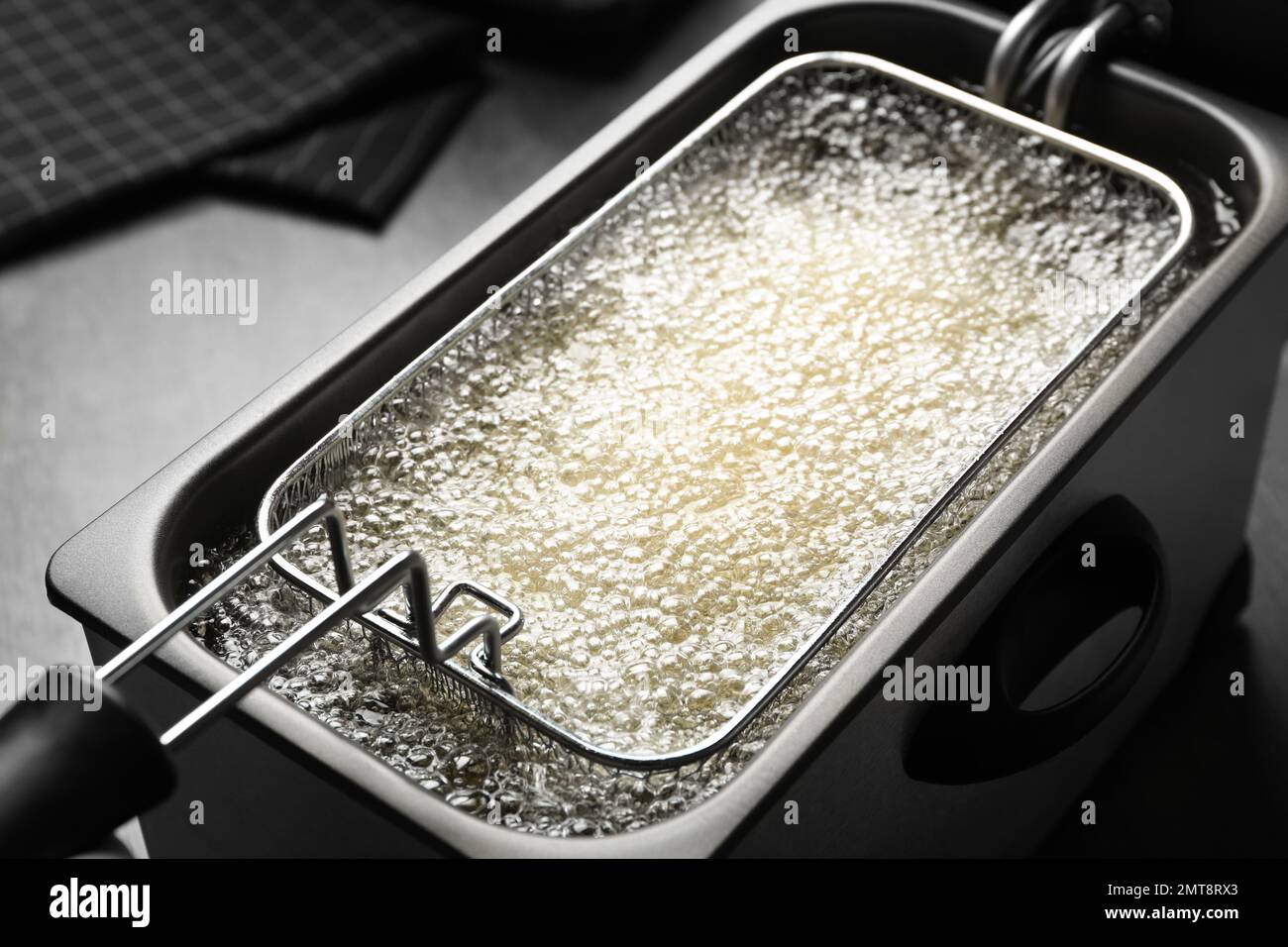 Cooking delicious french fries in hot oil Stock Photo - Alamy