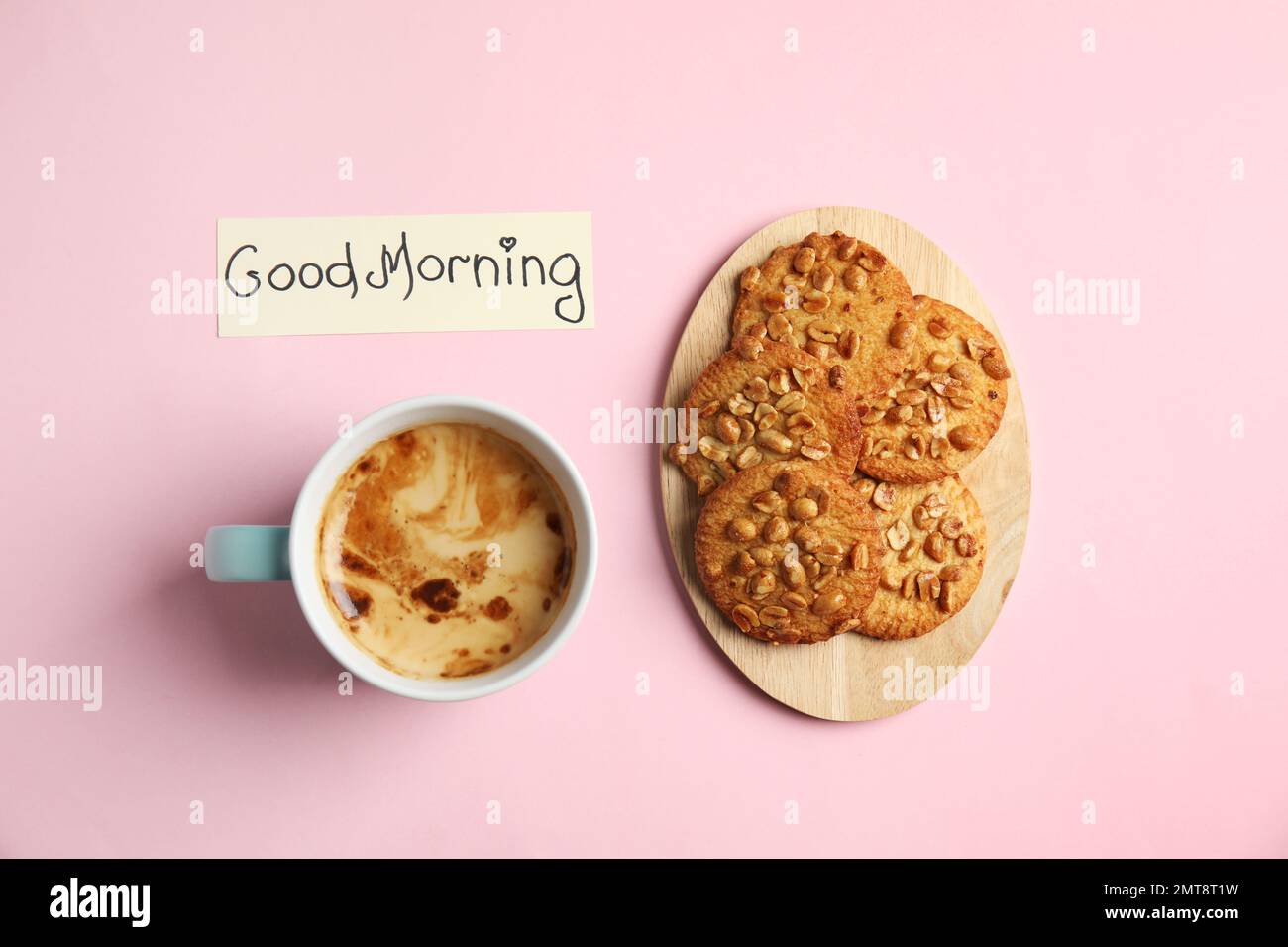 Delicious coffee, cookies and card with words GOOD MORNING on pink ...