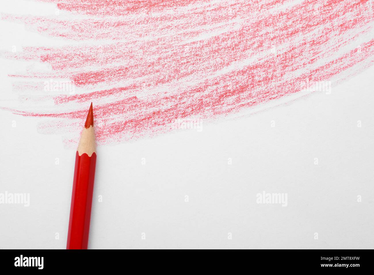 Red pencil on sheet of paper with drawing, top view Stock Photo - Alamy