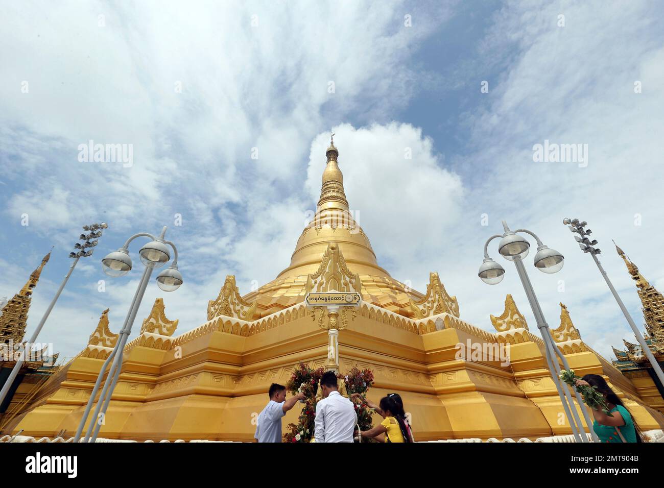 Buddhist devotees pour water on a Buddha statue at Uppatasanti Pagoda ...