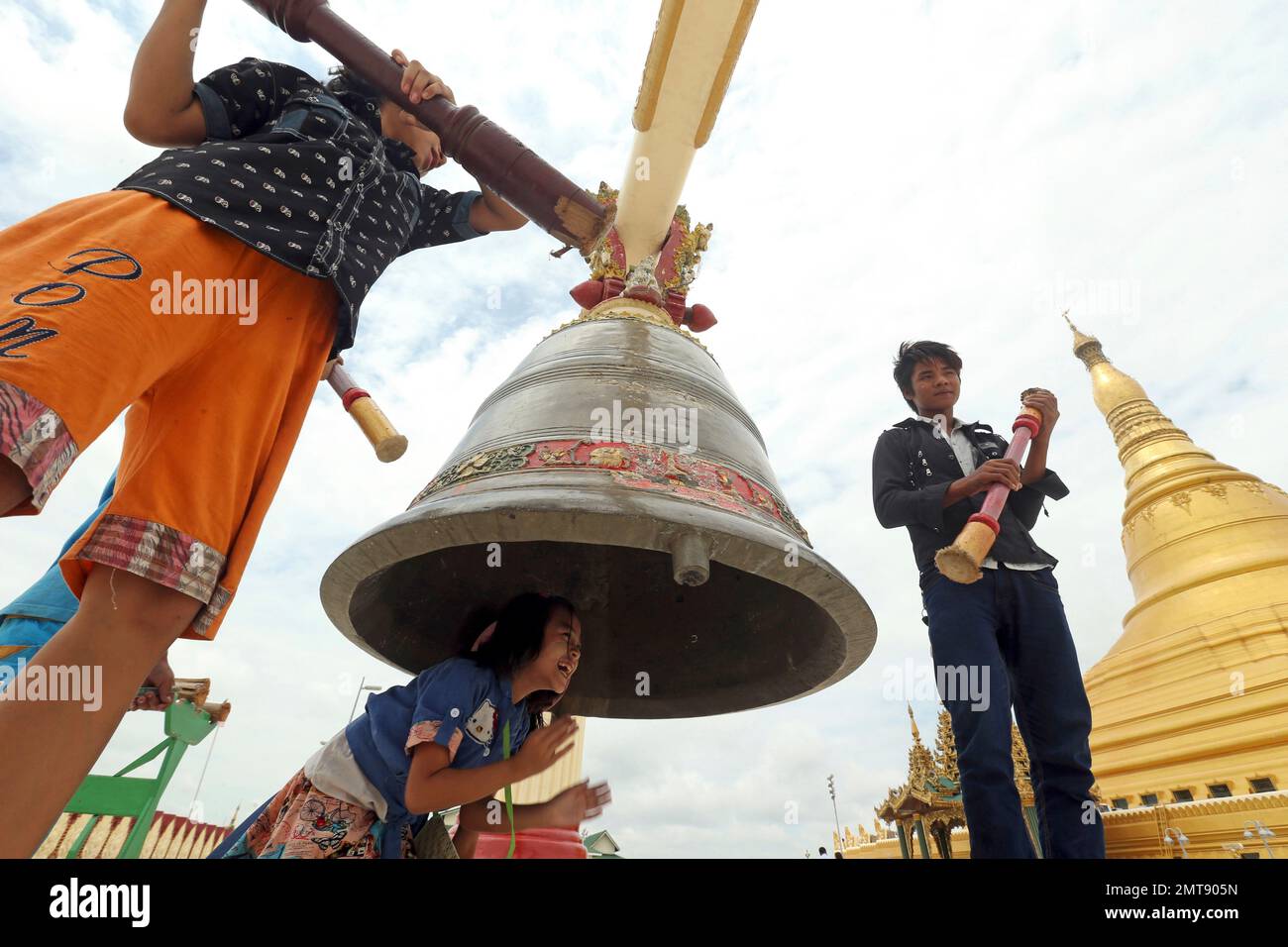 Buddhist devotees hit a giant bell the Uppatasanti Pagoda during ...