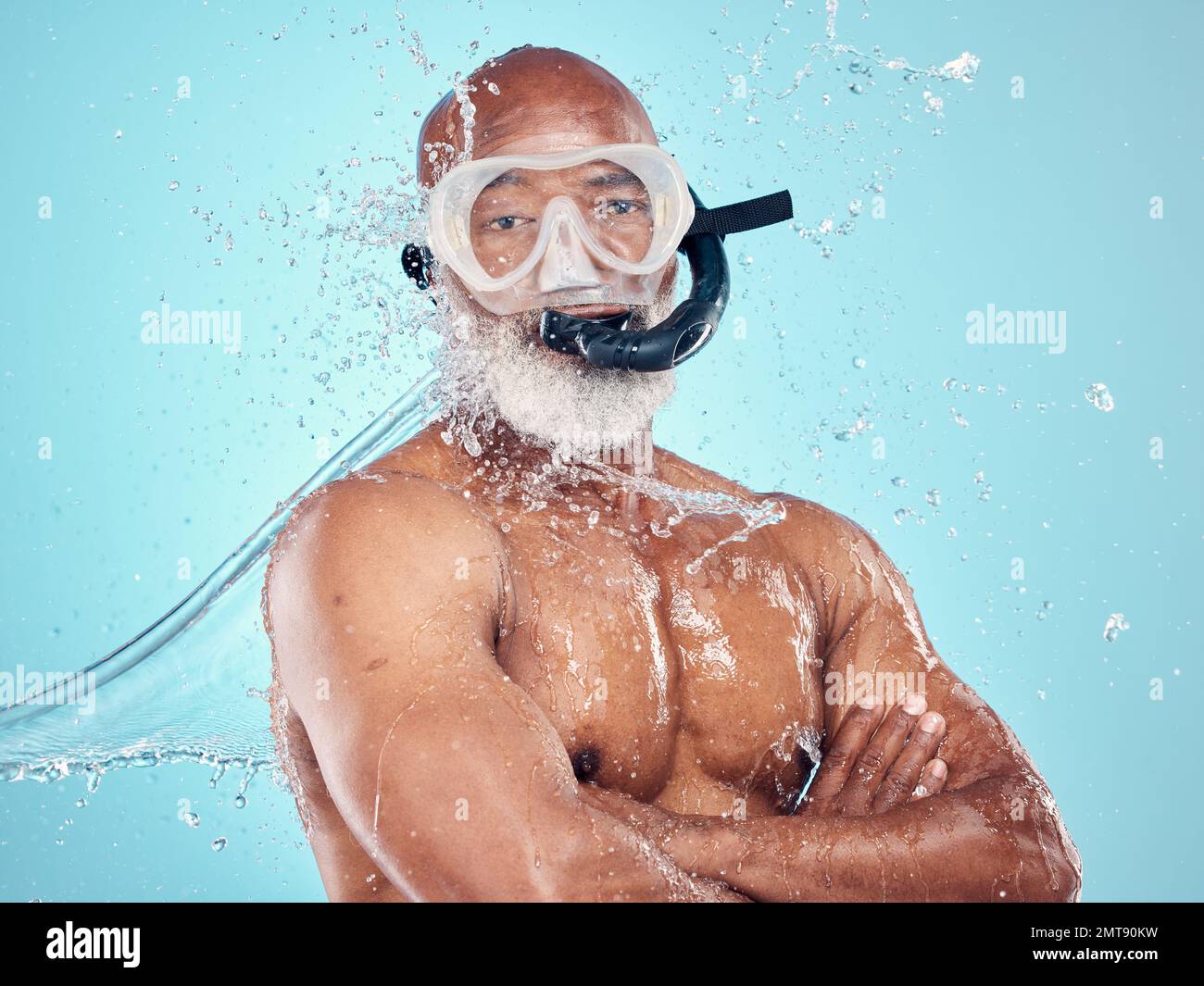 Water splash, snorkel and skincare of black man in studio isolated on blue background. Wellness ...
