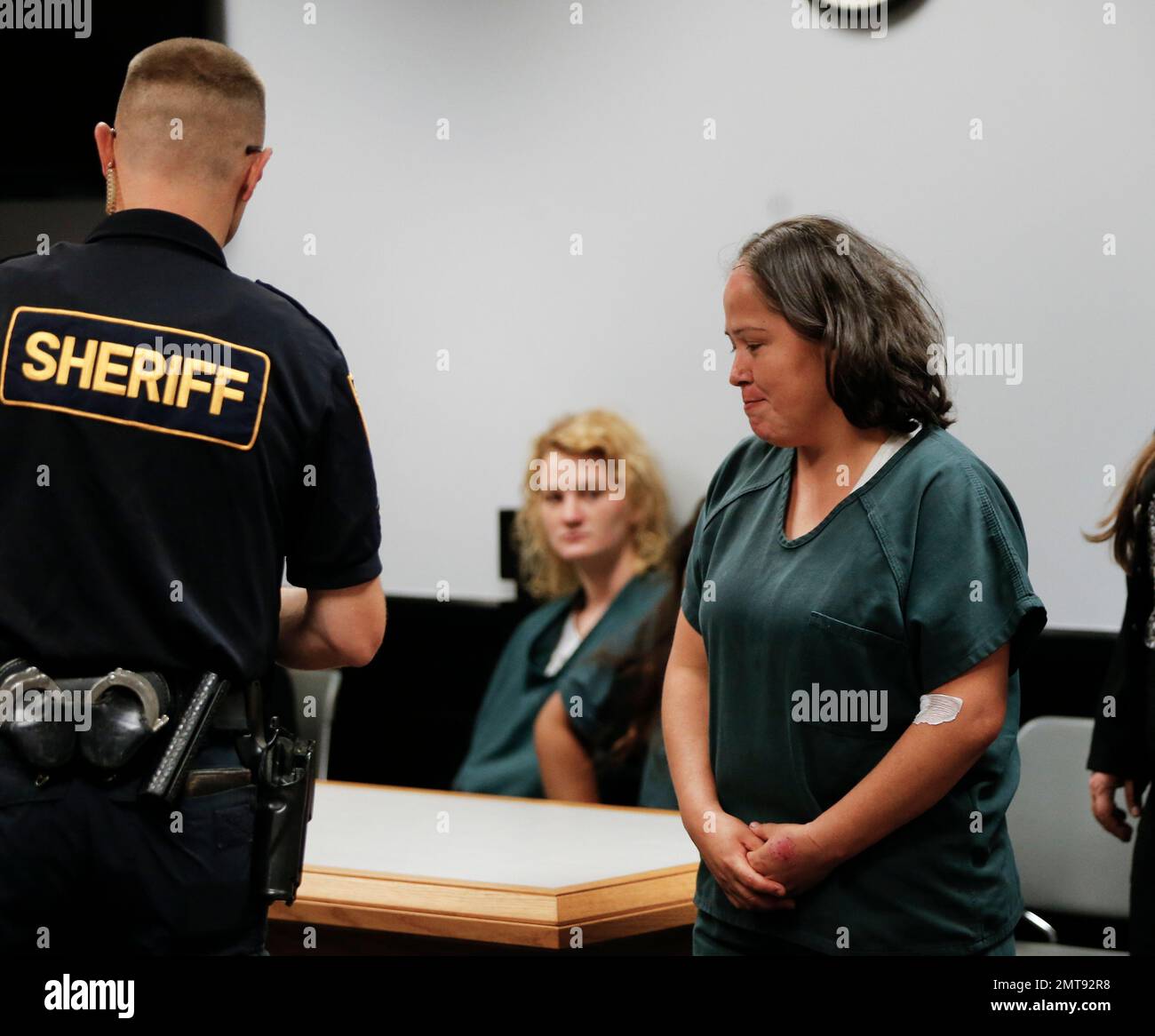 A deputy helps Isabel Martinez leave the stand during her first court ...