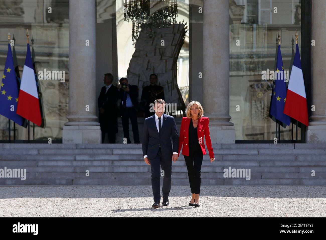 France's President Emmanuel Macron and his wife Brigitte, walk toward ...