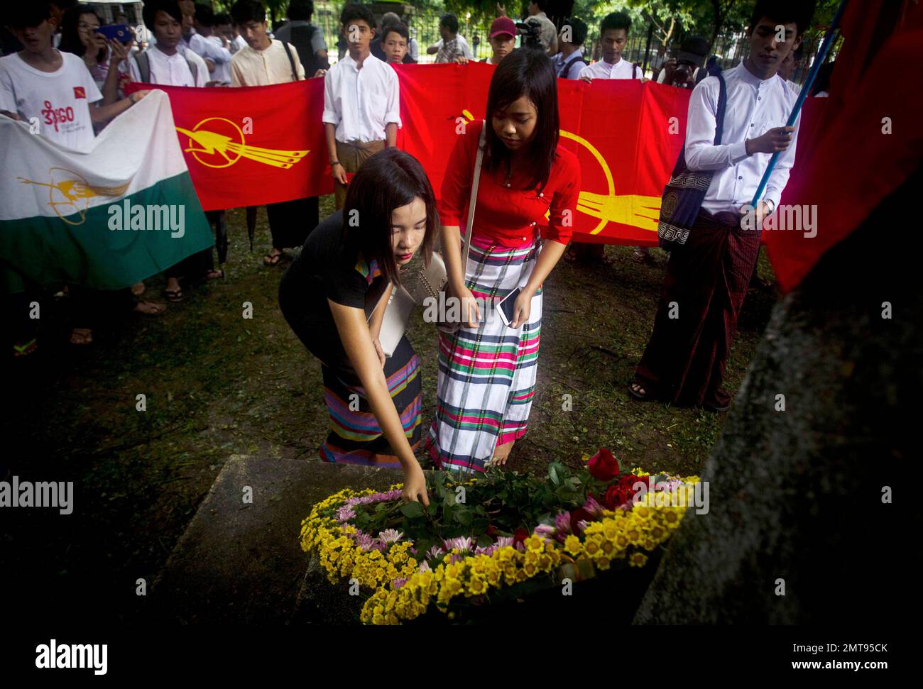 A student activist lays flower at a memorial to commemorate the 55th ...