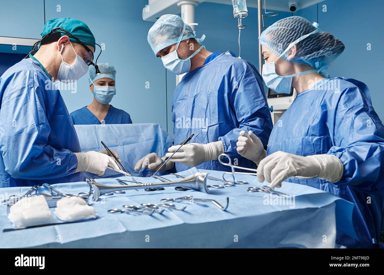 Group of concentrated surgeons while surgical operation in operating ...