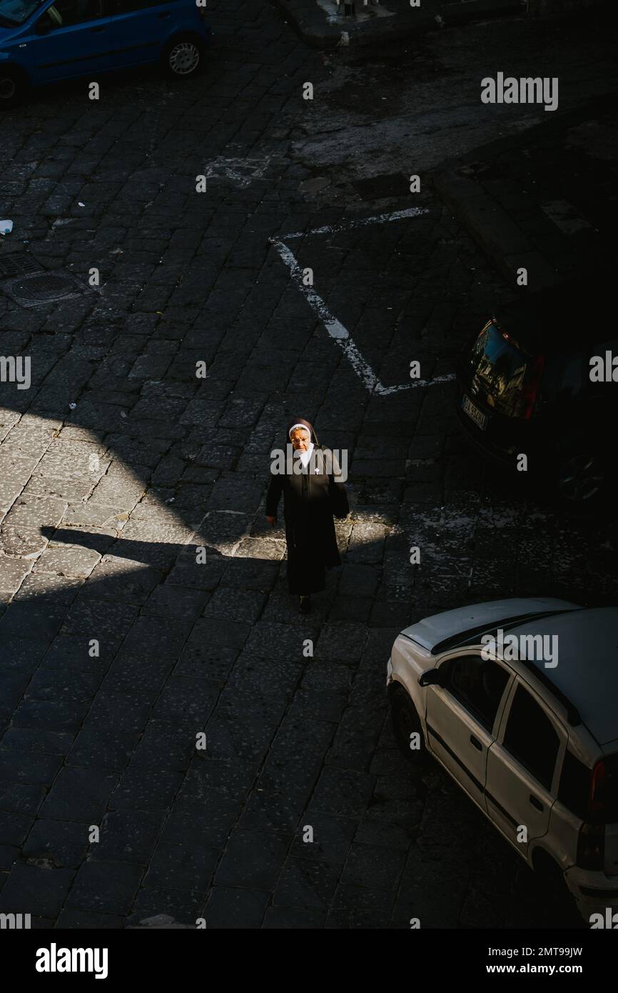 A nun coming out of Basilica of Santa Maria a Pugliano in Via Pugliano ...