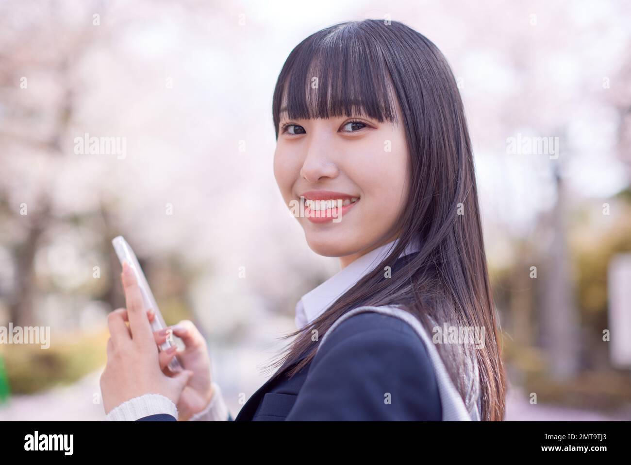 Japanese high school student portrait with cherry blossoms in full ...