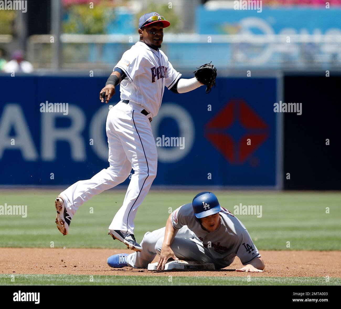 San Diego Padres shortstop Erick Aybar, left, leaps after making the ...