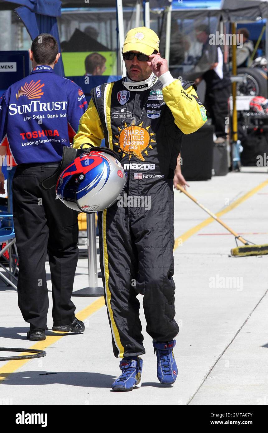 Patrick Dempsey stretches in his racing jumpsuit and helmet and gets ...