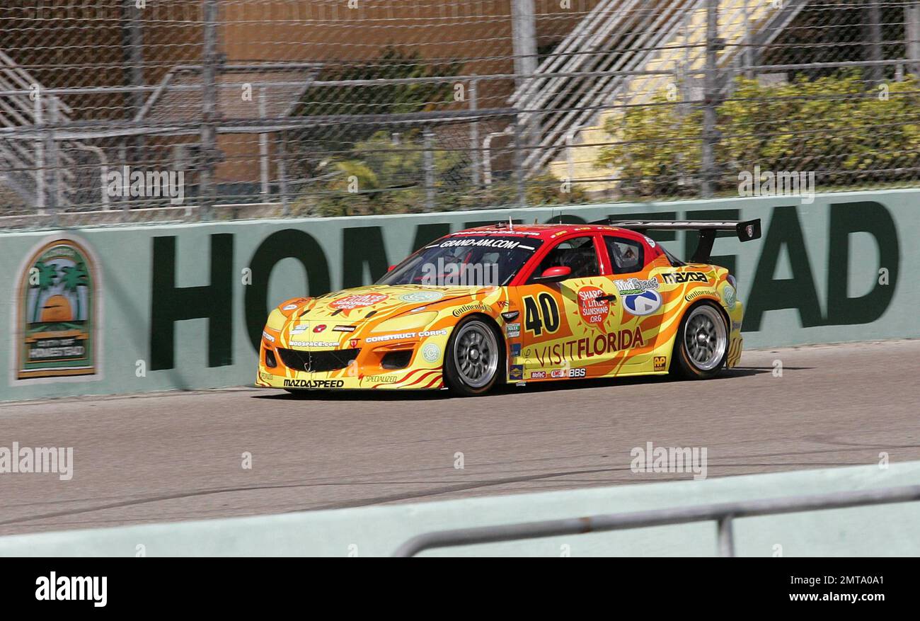 Patrick Dempsey stretches in his racing jumpsuit and helmet and gets ...